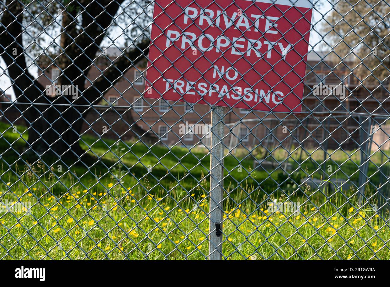 Bright red sign with white writing, Private property, no trespassing on ...