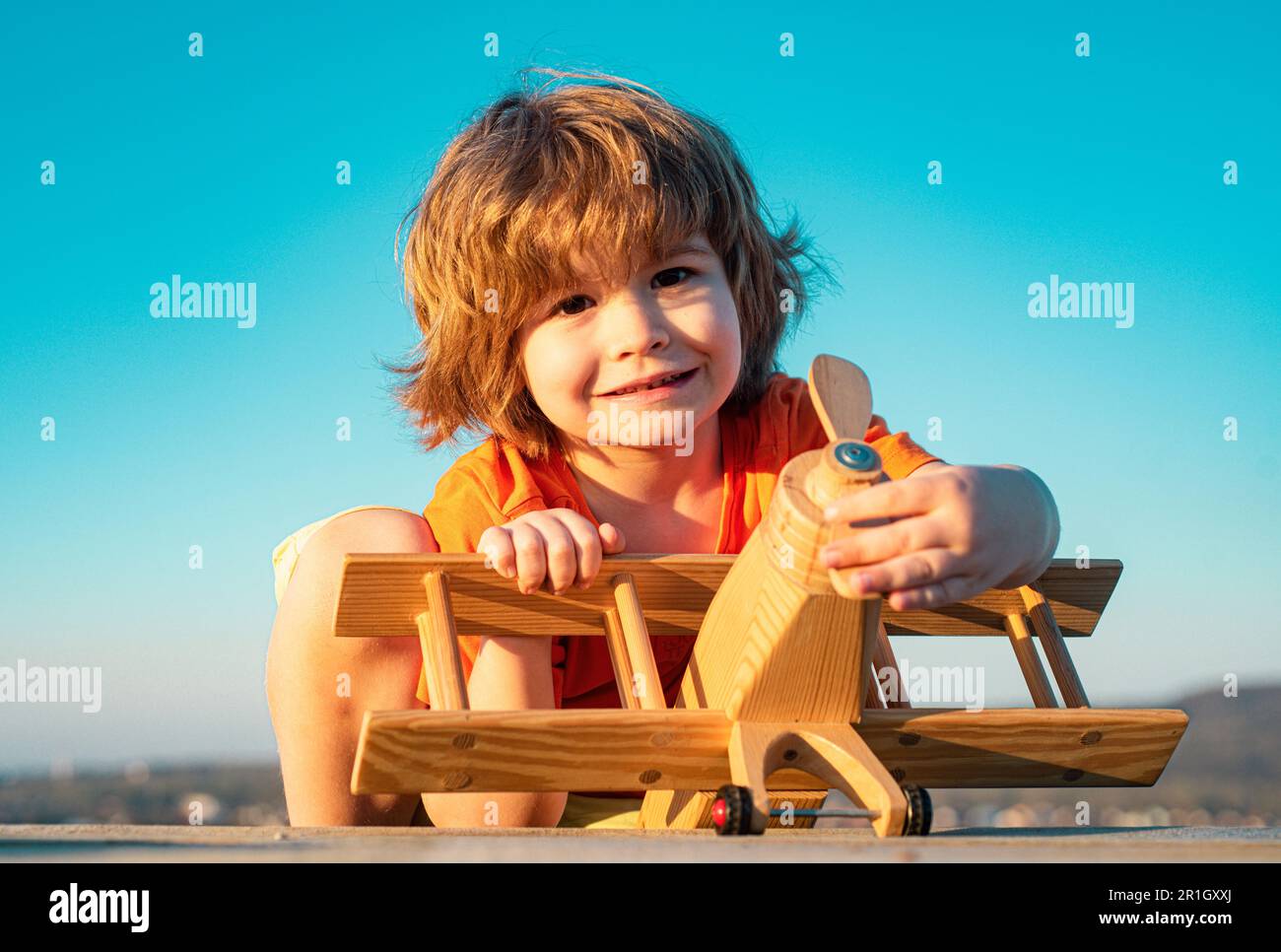 Little boy with wooden plane, boy wants to become pilot and astronaut ...