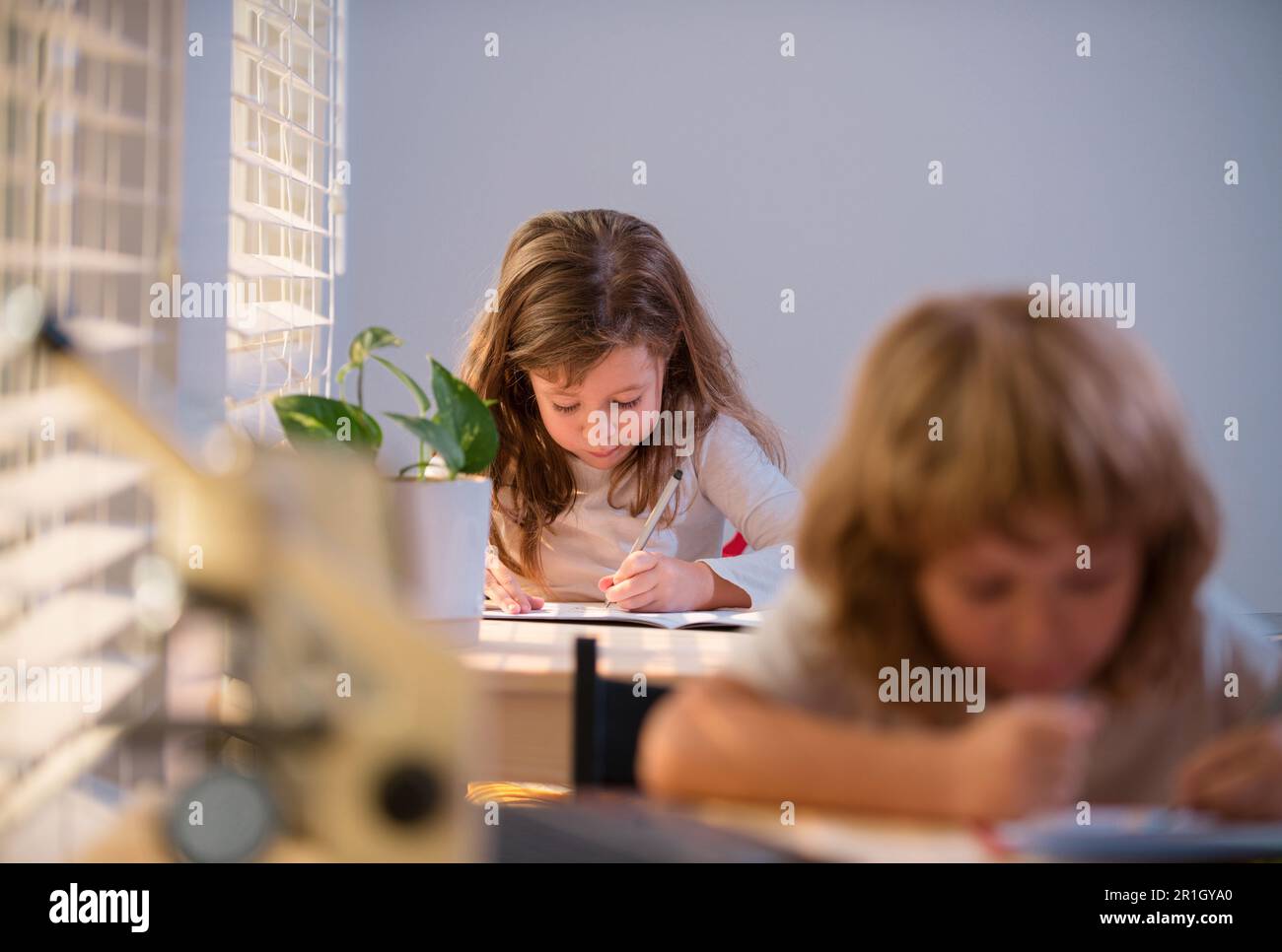 Children sitting at desk in school classroom and writing test Stock ...