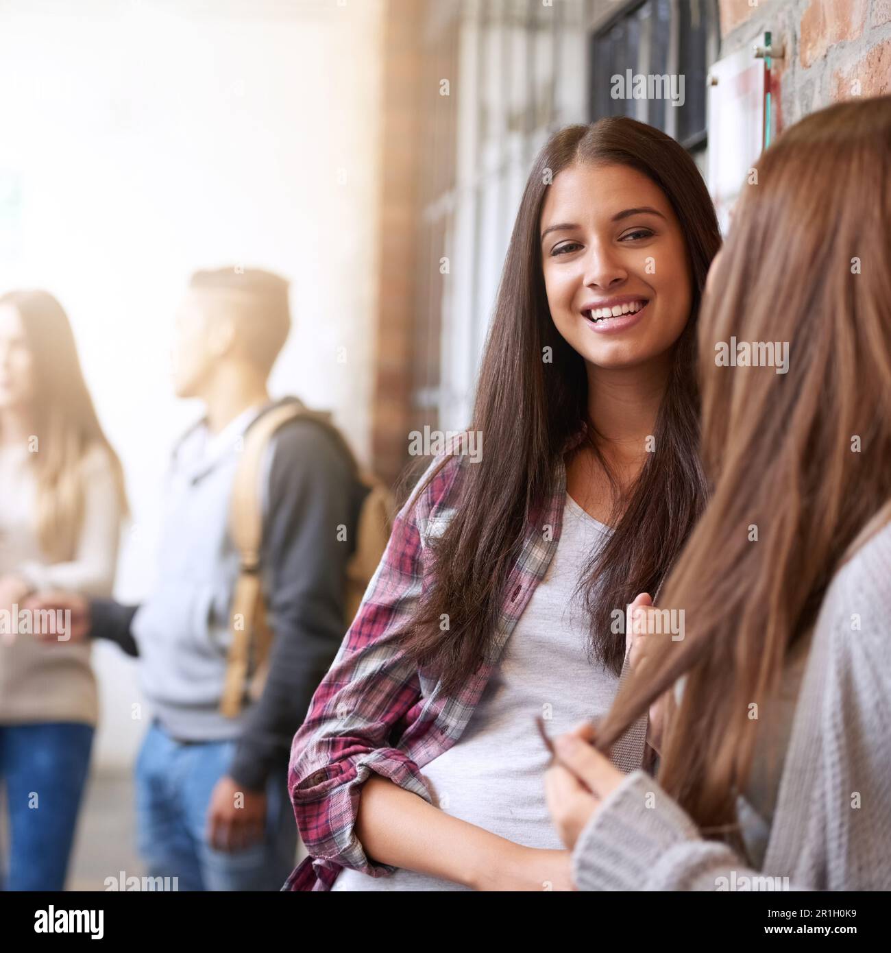 Girl friends, university hallway and female talking with happiness and ...