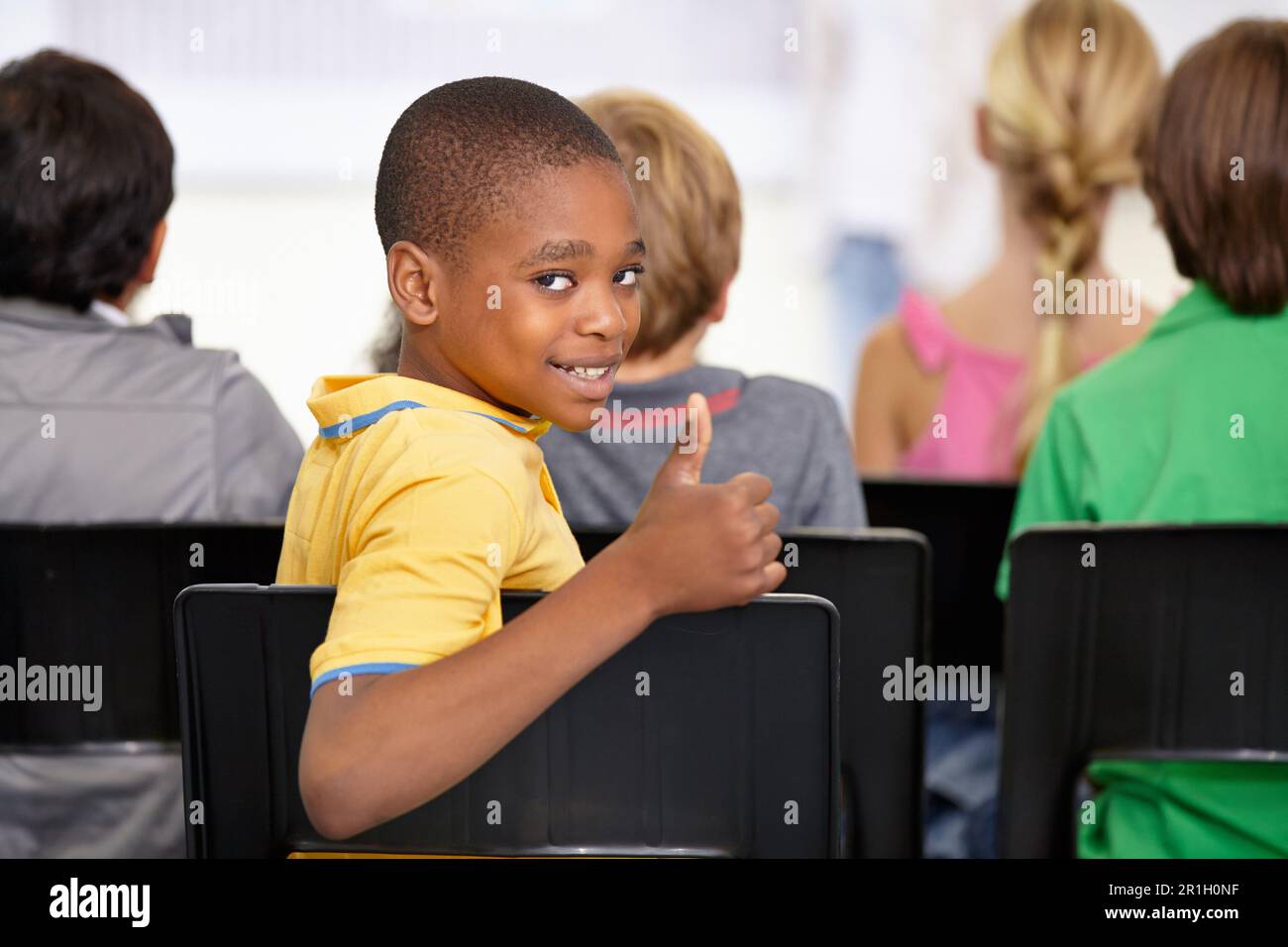 Portrait, black child and thumbs up of student in classroom, elementary ...