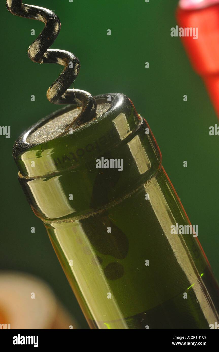 Close up of a bottle of wine being opened by a bottle opener Stock ...