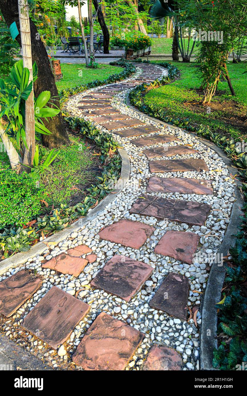 Alley, pedestrian path along the tree in tropical garden Stock Photo ...