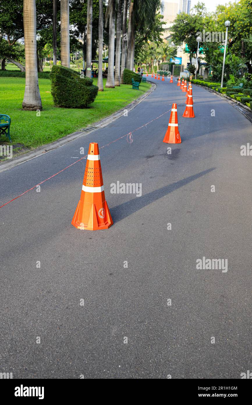 Row of orange fluorescent, reflex traffic cones on road Stock Photo - Alamy