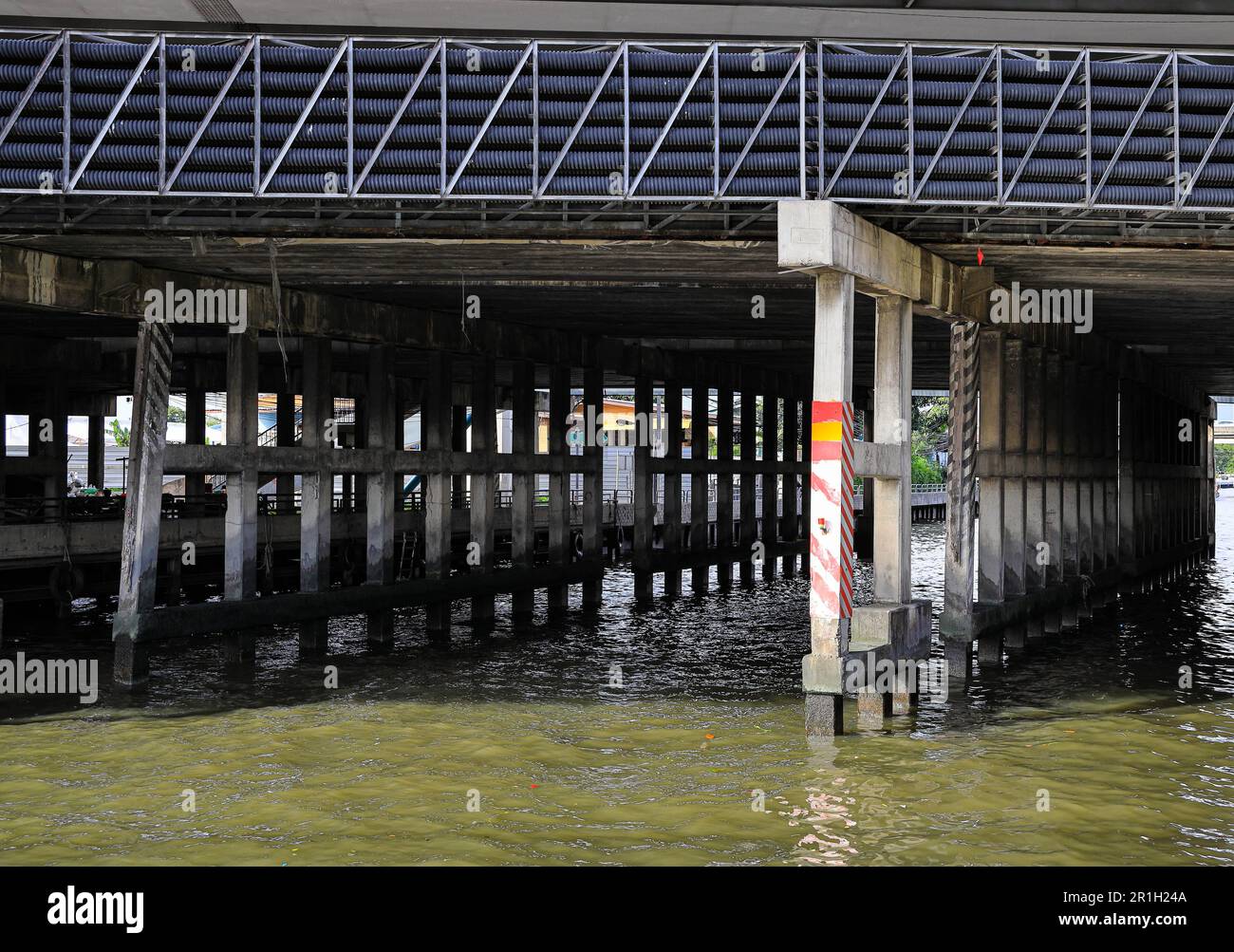 Substructure of concrete bridge over water, can see many of bunting or ...