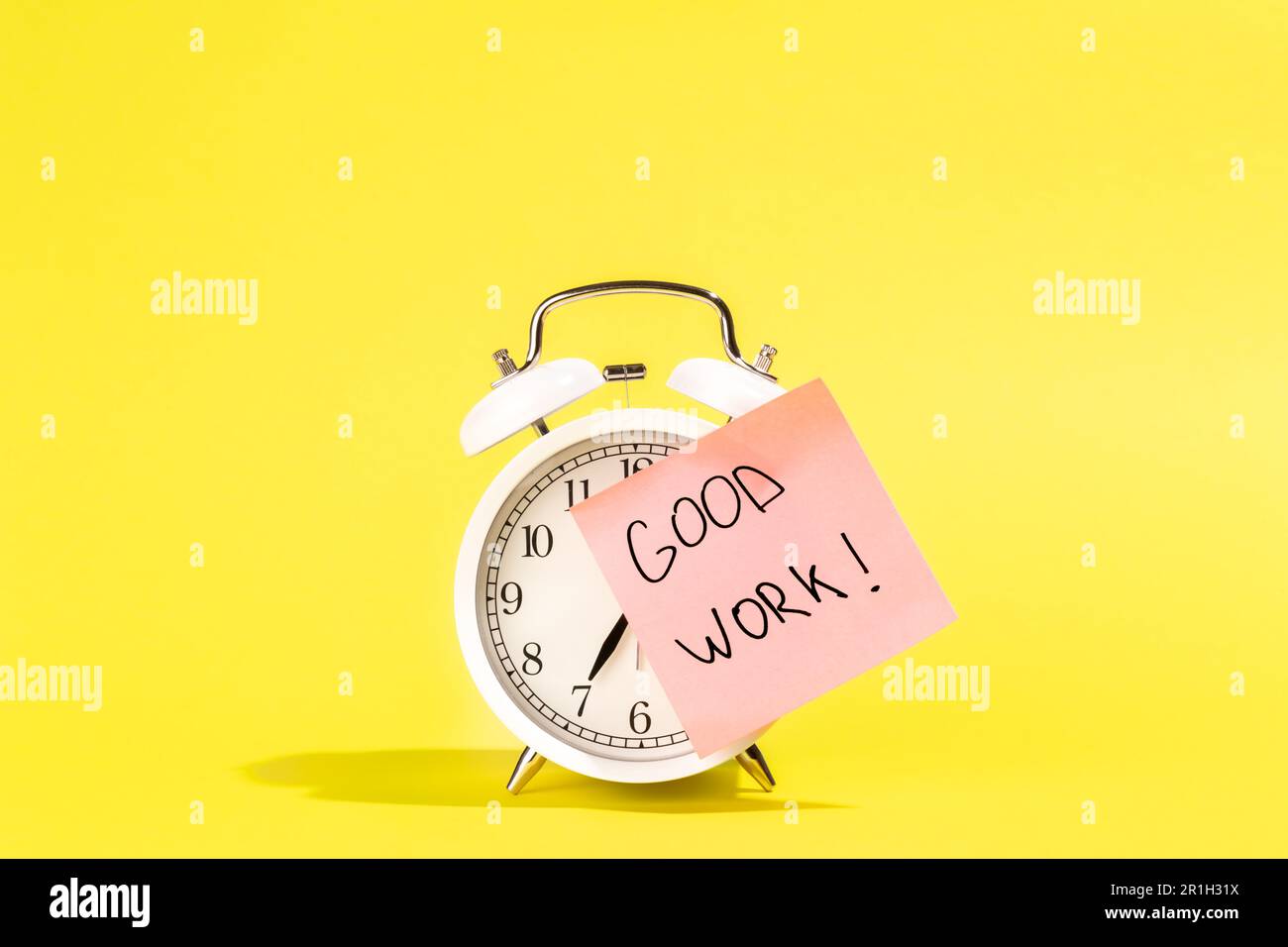 Alarm clock and paper reminder with inscription Good work, isolated ...
