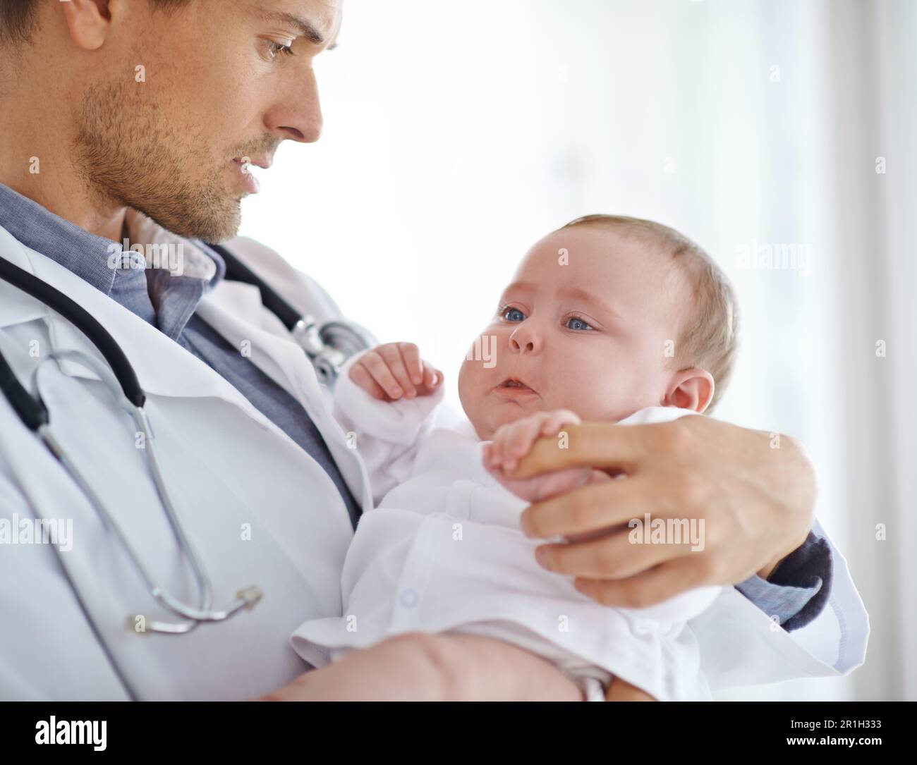 Doctor, sick and sad baby in clinic for healthcare assessment ...