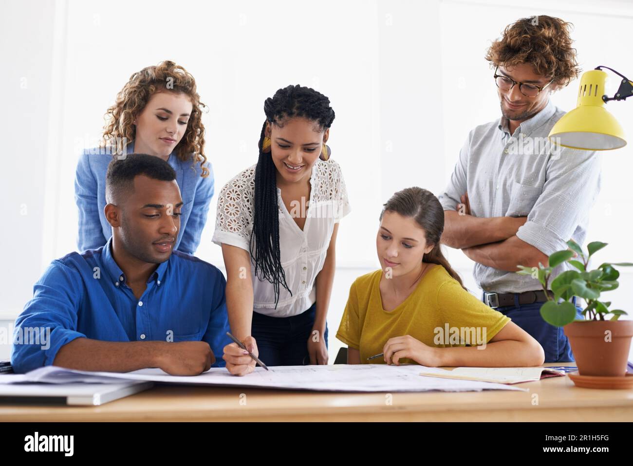 Diversity, business people and writing on documents in teamwork ...