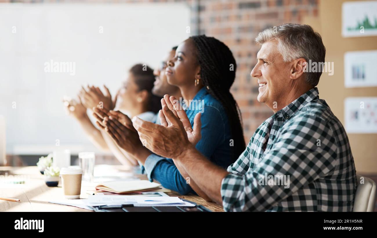 Everyones a winner today. a group of businesspeople clapping hands ...