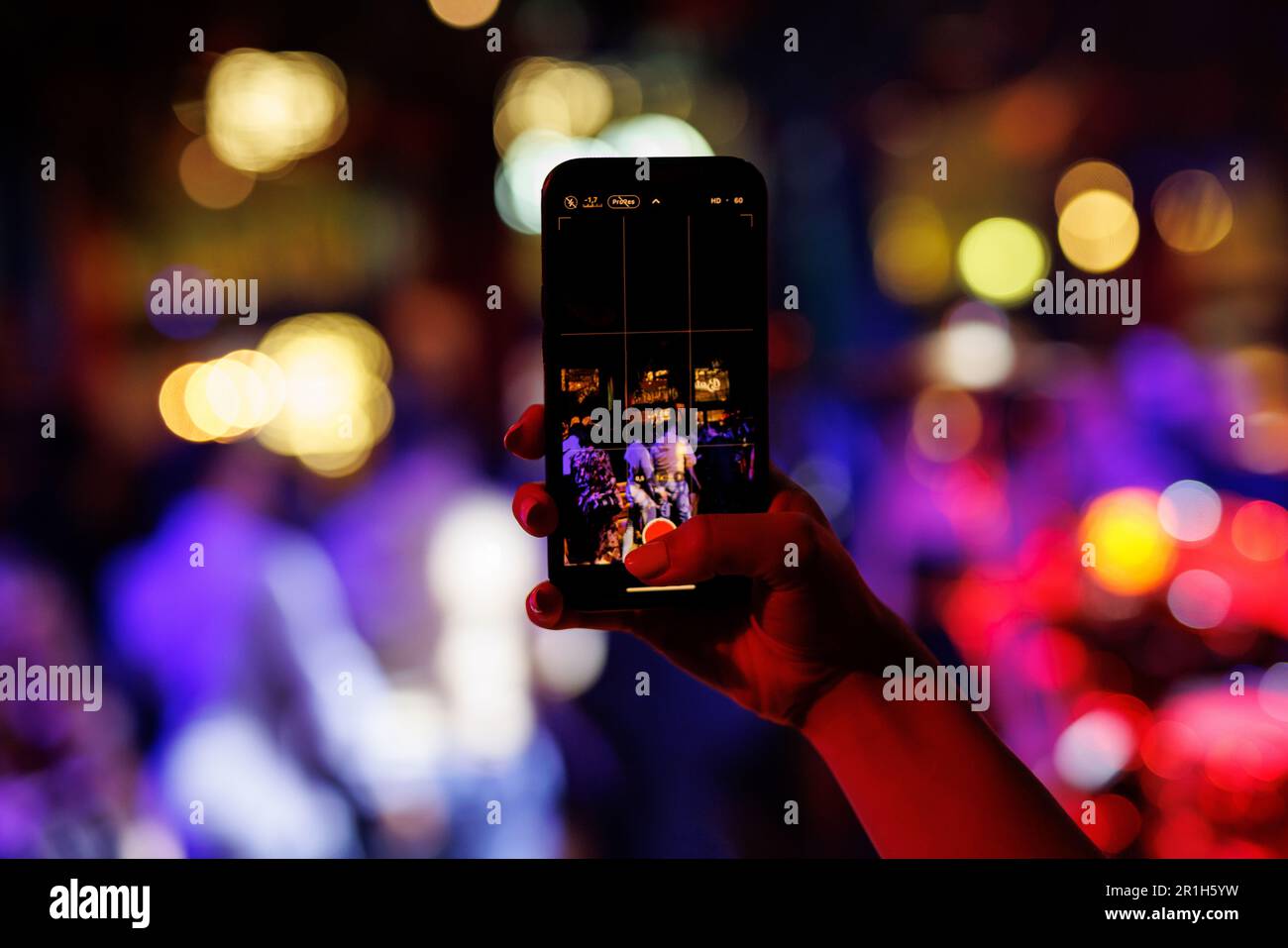 Using a smartphone for filming concert party Stock Photo - Alamy