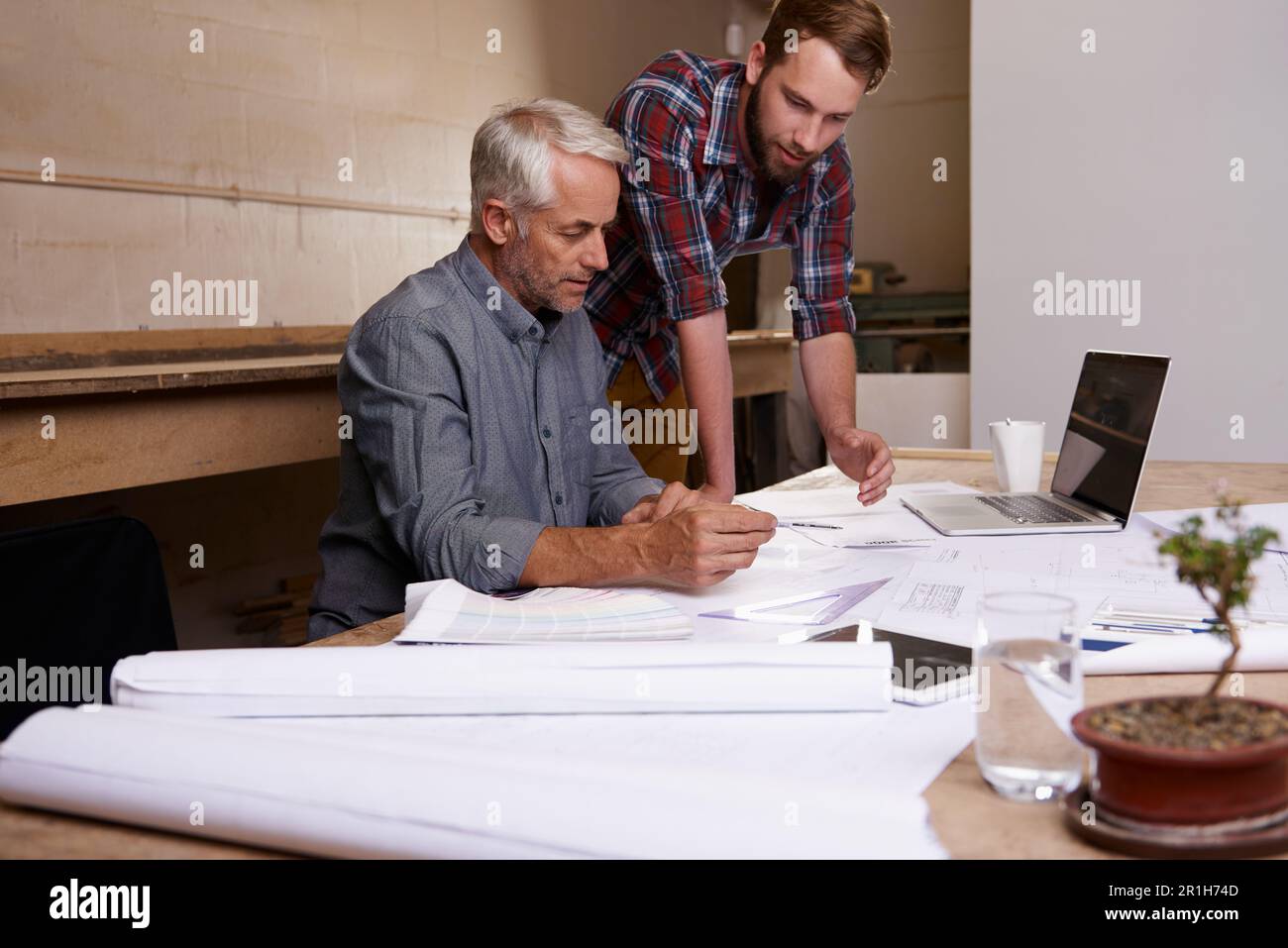 Architect, teamwork and men with blueprint in workshop for ...