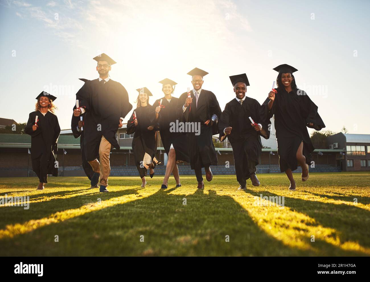 The future belongs to us. a group of university students running after ...
