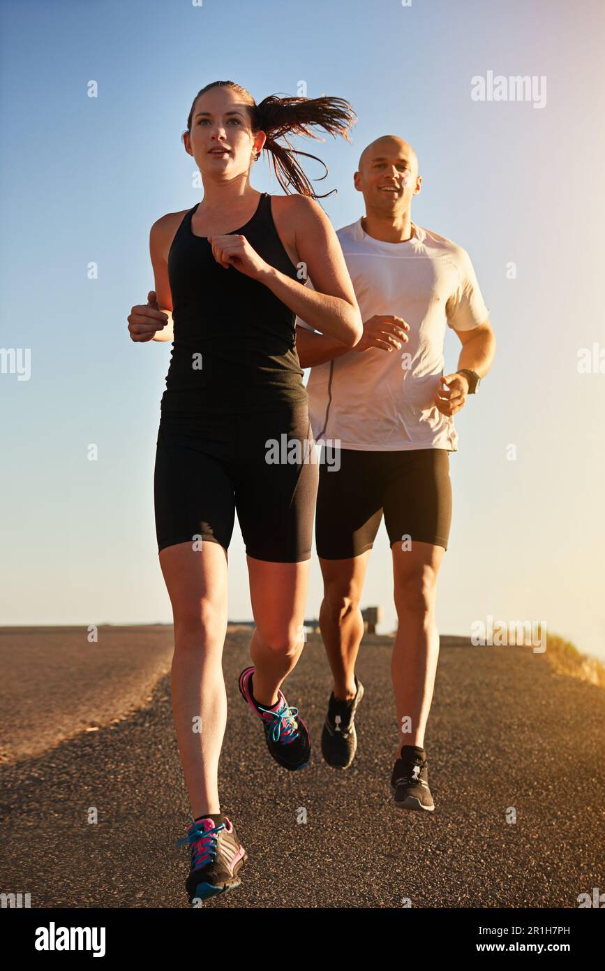 Sunrise, marathon and friends running as workout or morning exercise for health and wellness ...