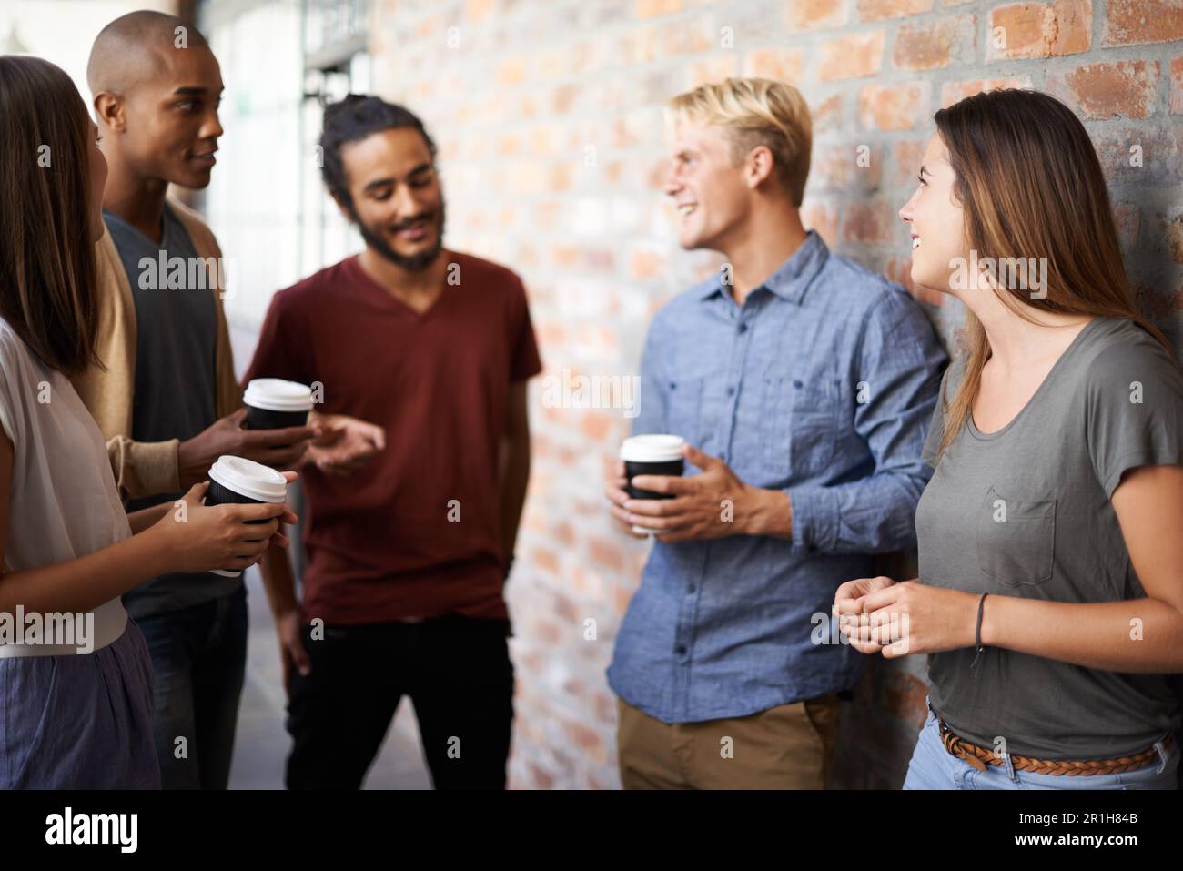 Coffee, friends and students talking in a college hallway for ...