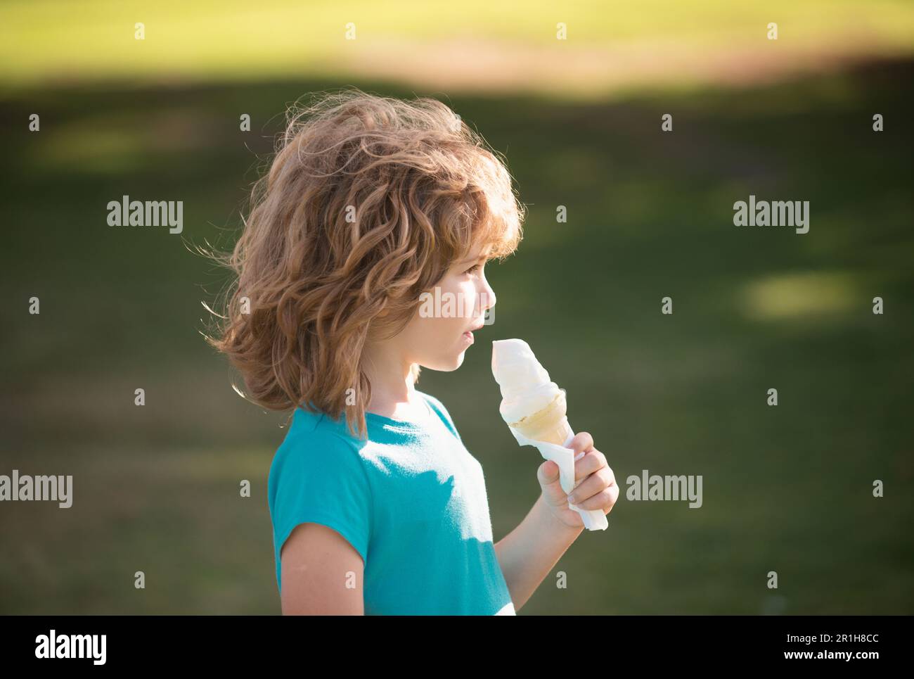Cute child boy eating ice cream. Close up caucasian kids face. Closeup ...