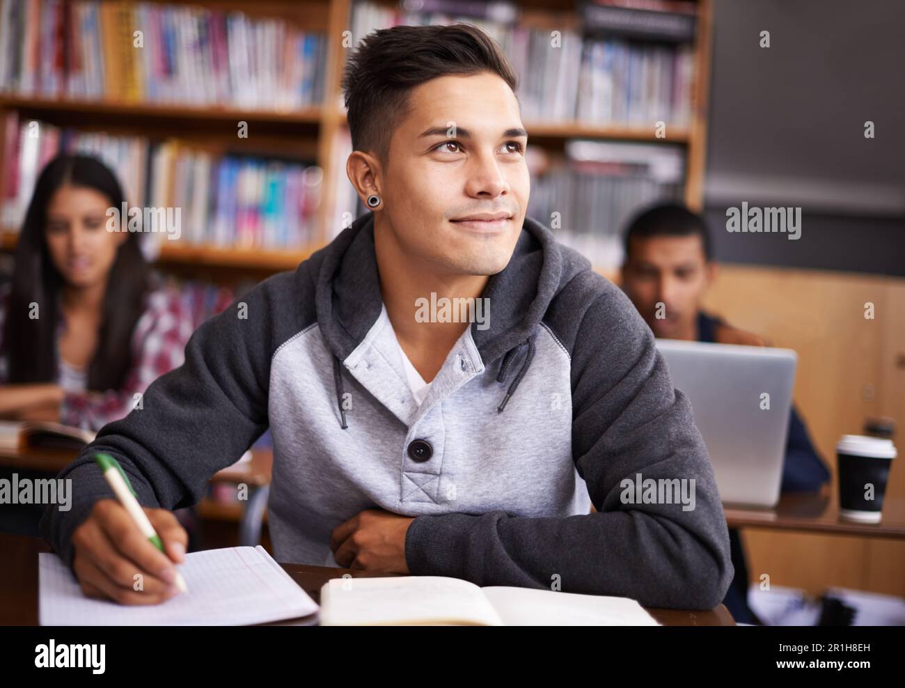 Thinking, writing and college with man in library for education ...