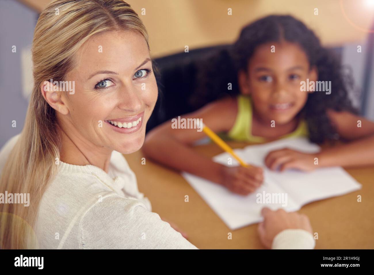 Portrait, woman and kid to learn for reading on desk in the classroom ...