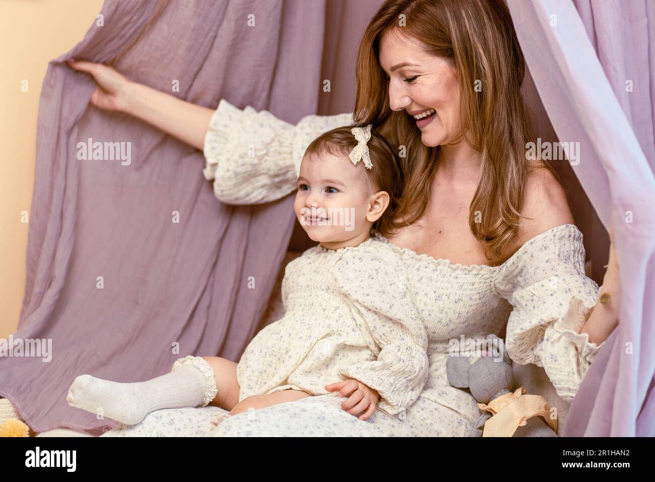 Young mom having loving time with her baby daughter Stock Photo - Alamy
