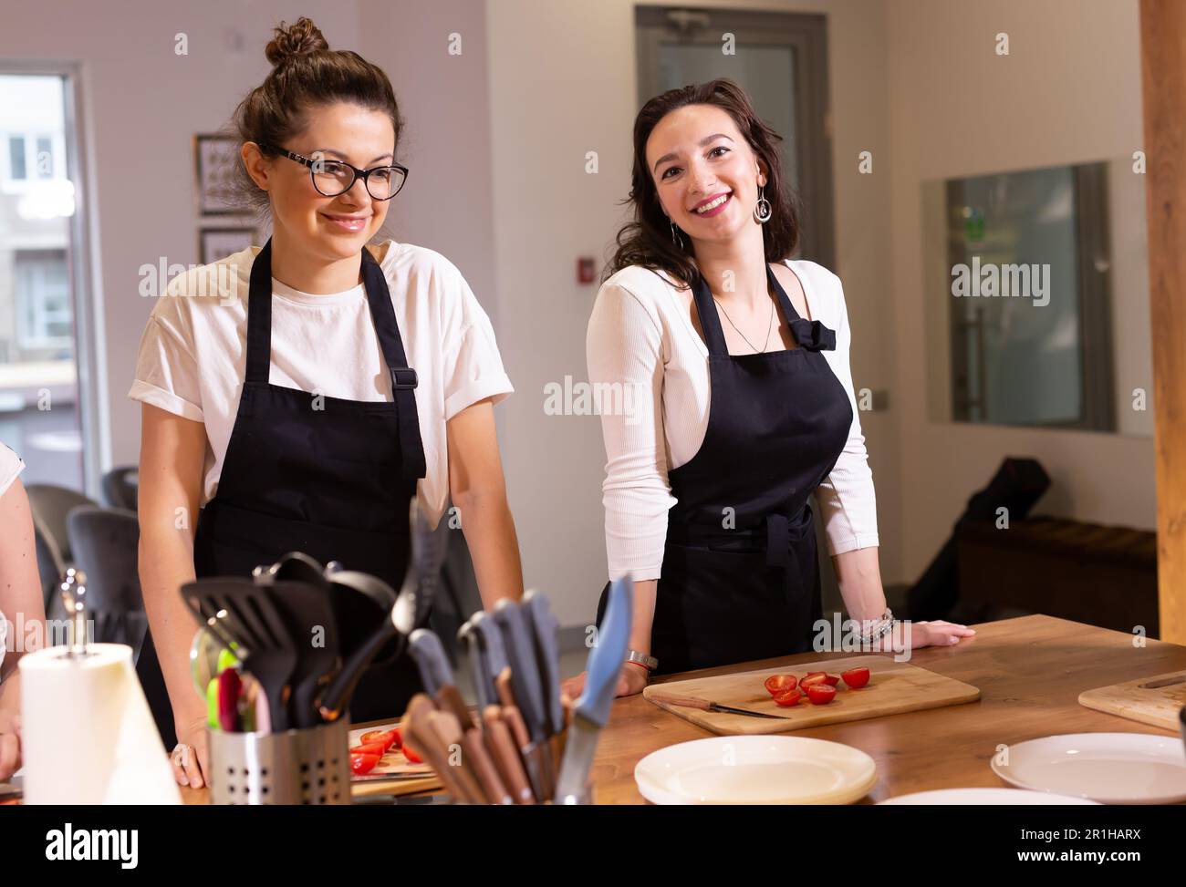 Two professional female chefs cooking dishes in large kitchen Stock ...