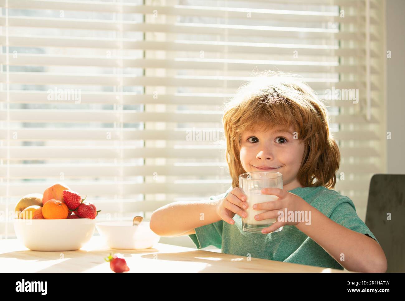 Kids eating. Close up of cute little boy kid drink tasty organic milk ...
