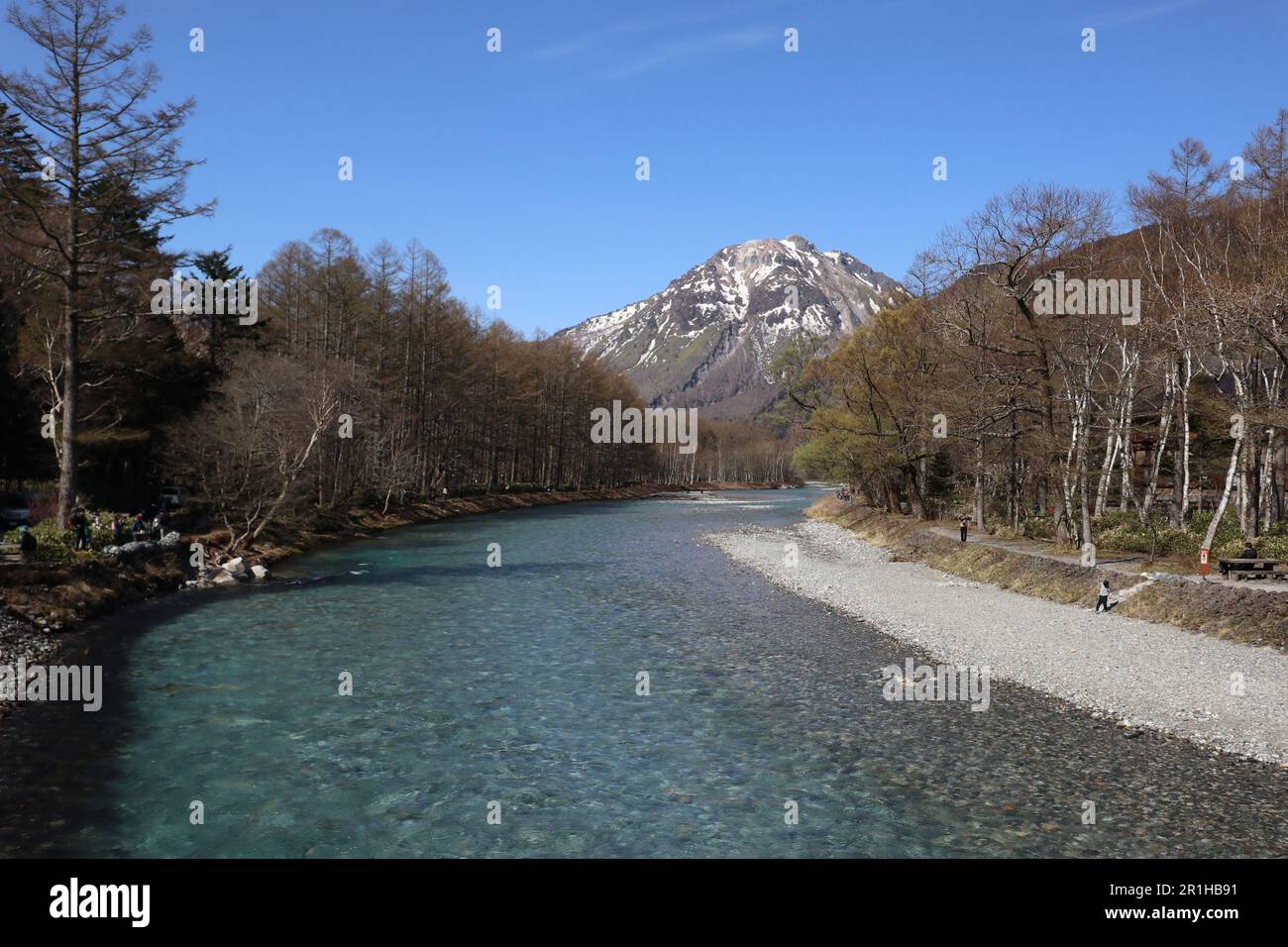 The clear Azusa River and snow-capped Mount Yakedake viewed from ...