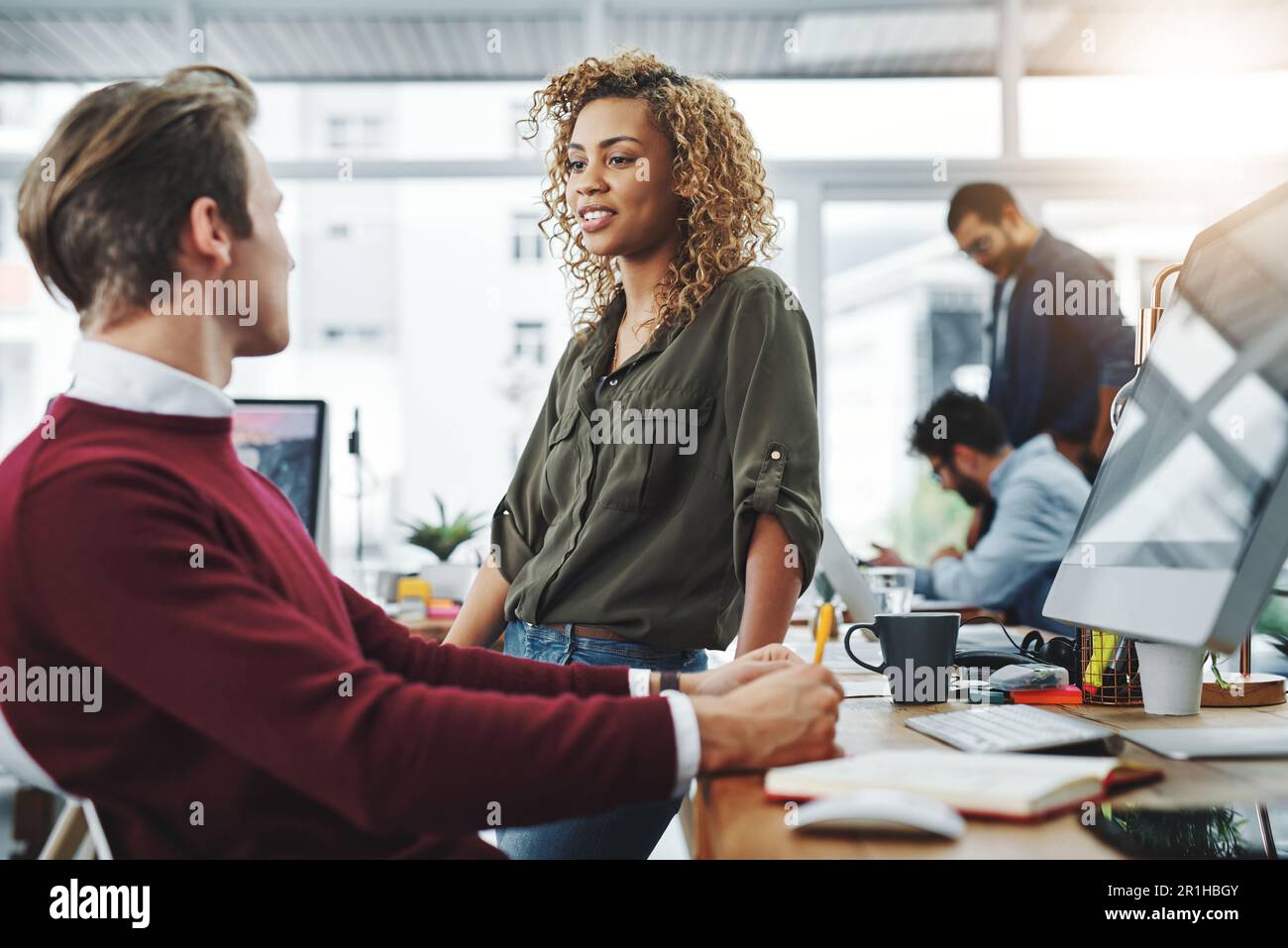 Mind if I ask for your help. two young colleagues having a friendly ...
