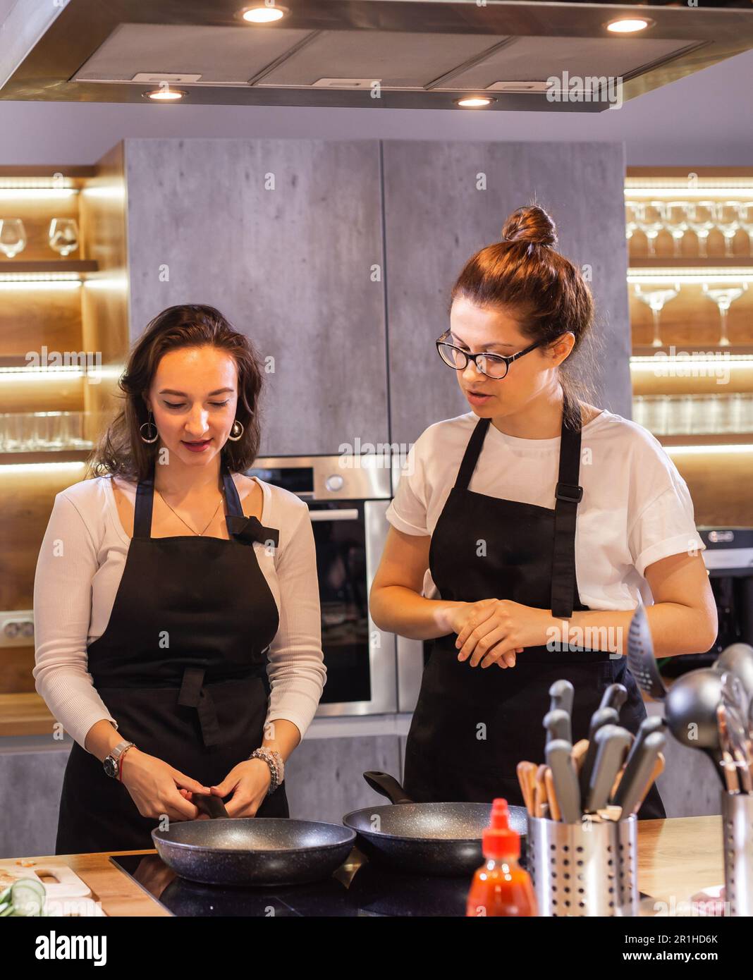 Two funny professional female chefs cooking food in large kitchen Stock ...