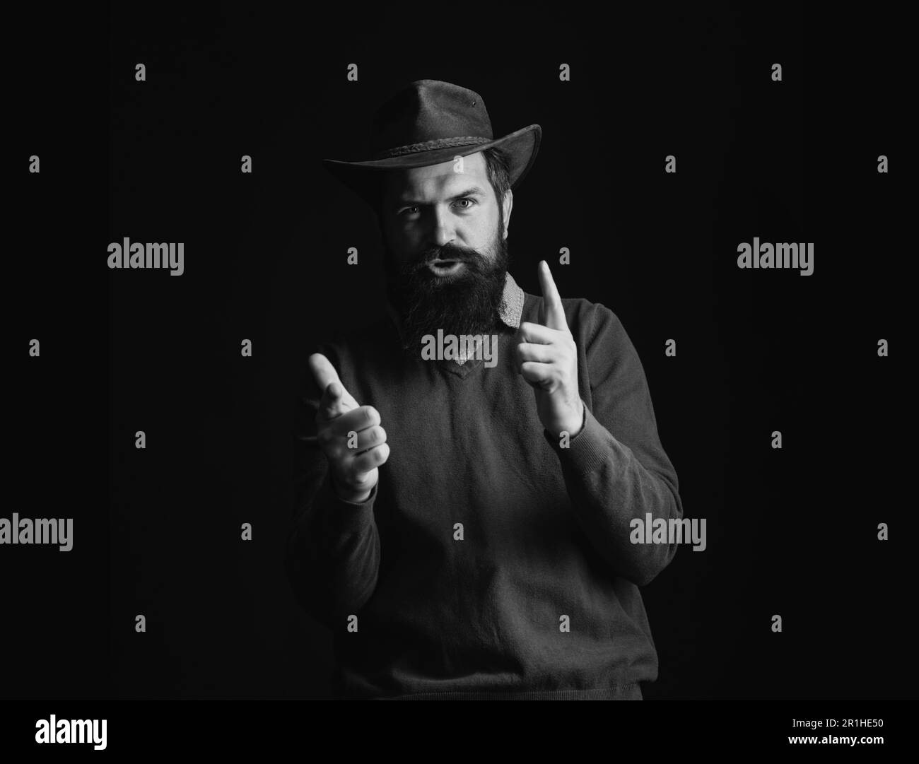 Bearded cowboy man in cowboy hat. Wild west guns, finger revolver ...