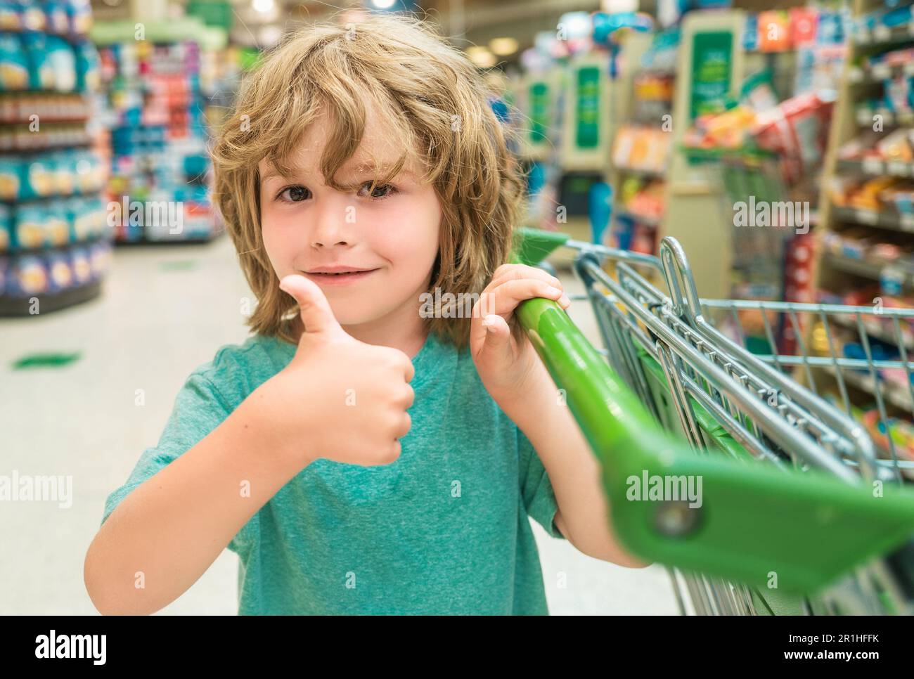 Portrait of child in grocery shopping in supermarket, Boy with a ...