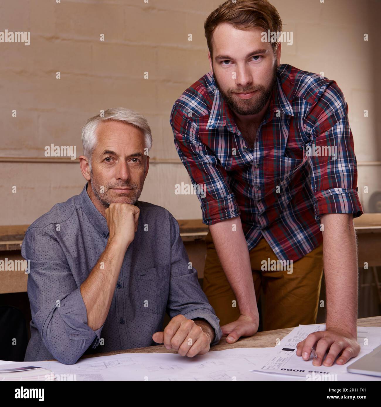 Architecture, teamwork and portrait of men in workshop with blueprint ...