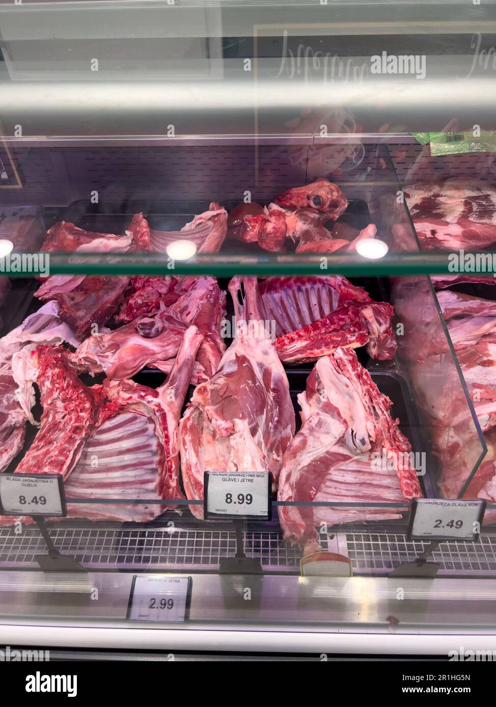 Raw lamb meat on the ribs lies in the refrigerator in the supermarket ...