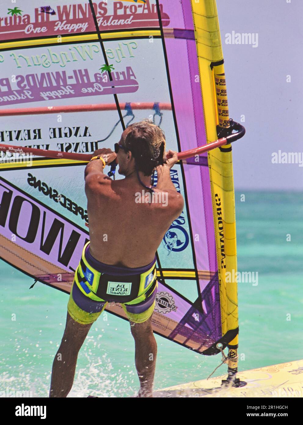 Aruba: Yong man windsurfing (or boardsailing) in Aruba's ideal ...