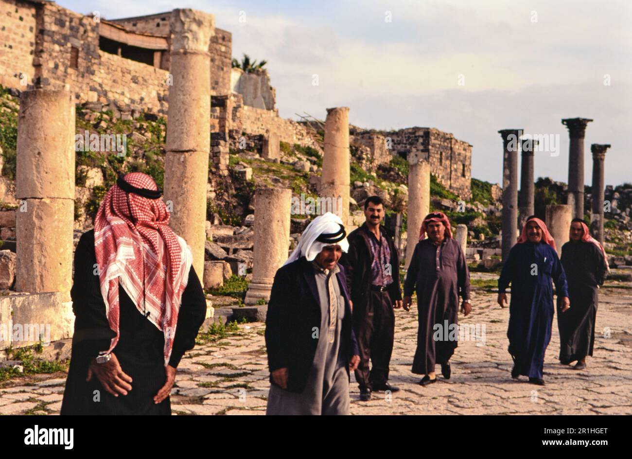 Jordan: Arab men in traditional dress at the ruins of Umm Qais. Photo ...