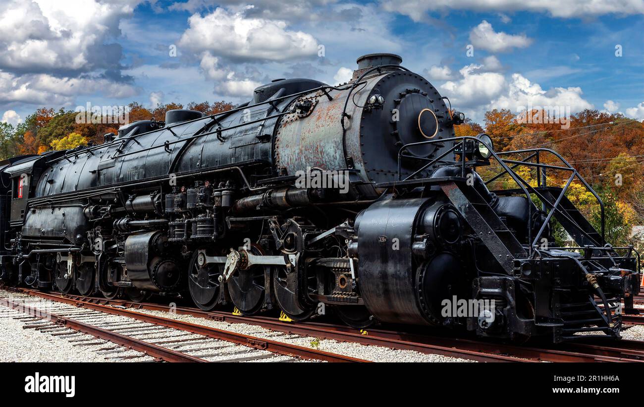landscape with a a vintage steam engine train showing its age under a ...