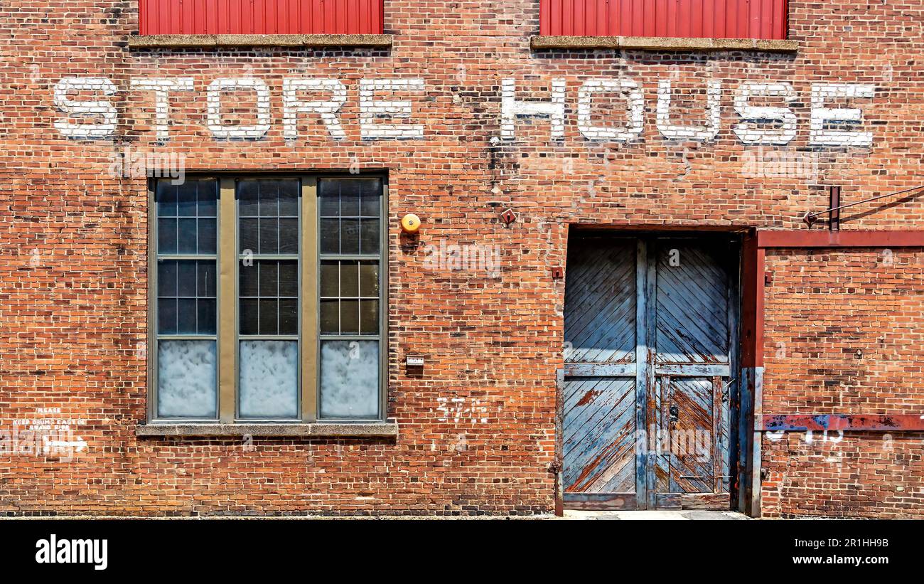 Warehouse brick front background with Store House stenciled above door ...