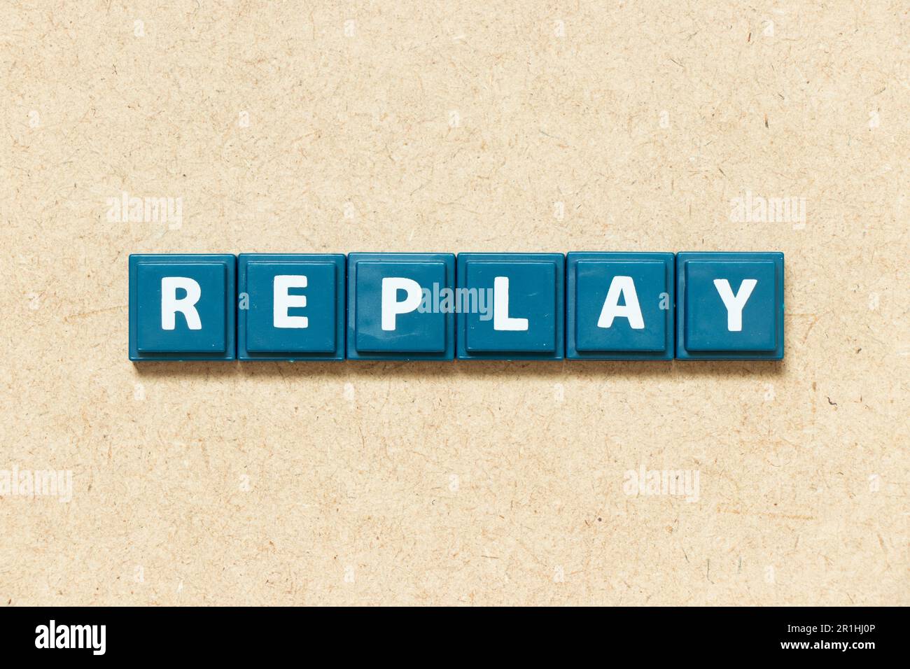Tile alphabet letter in word replay on wood background Stock Photo - Alamy