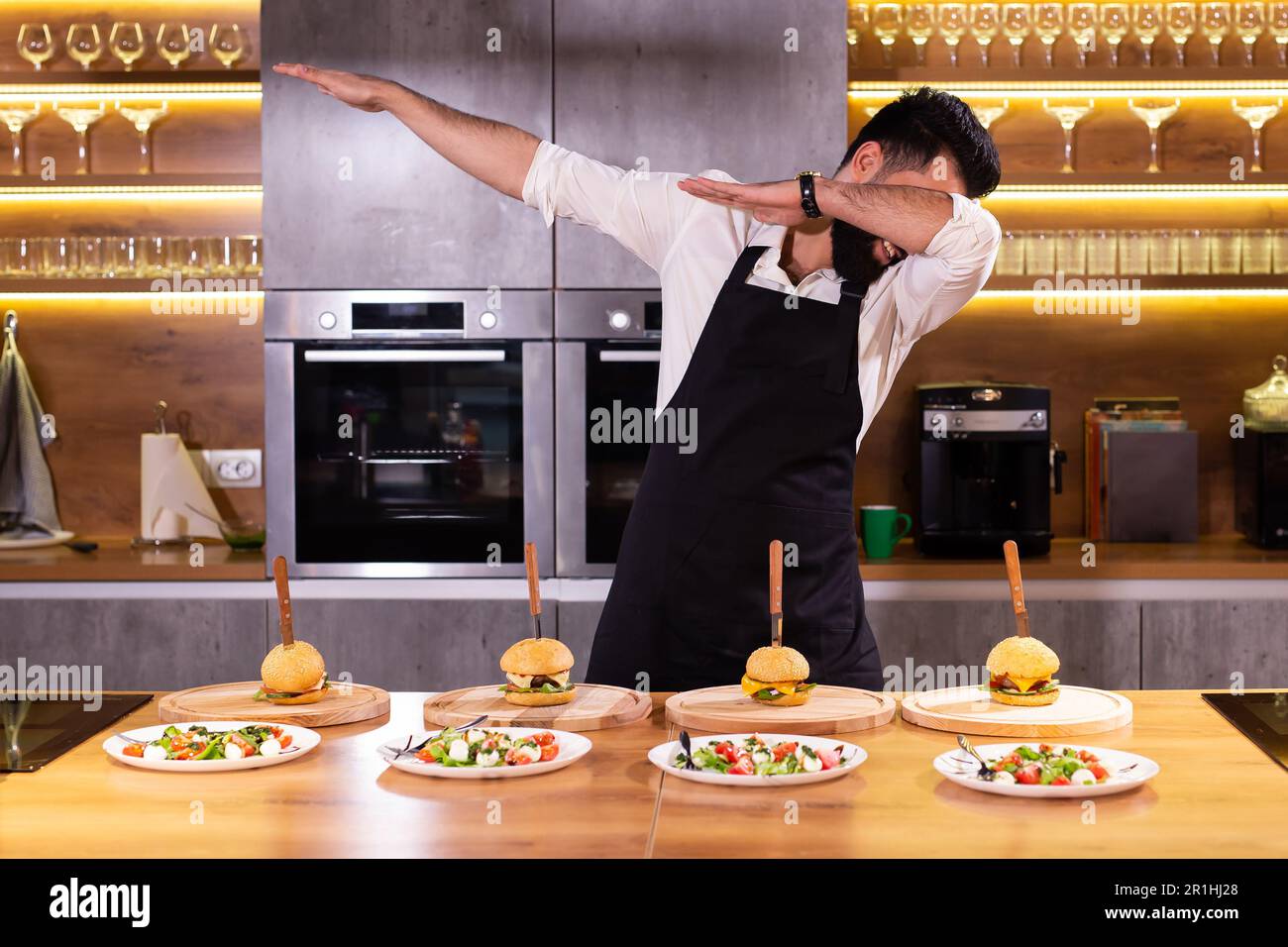 Chef frying steaks for a dinner party in kitchen Stock Photo - Alamy