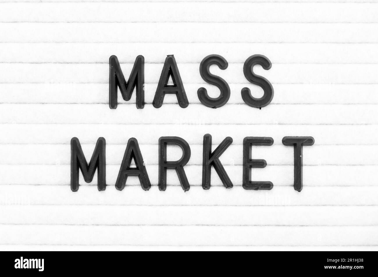 Black color letter in word mass market on white felt board background ...