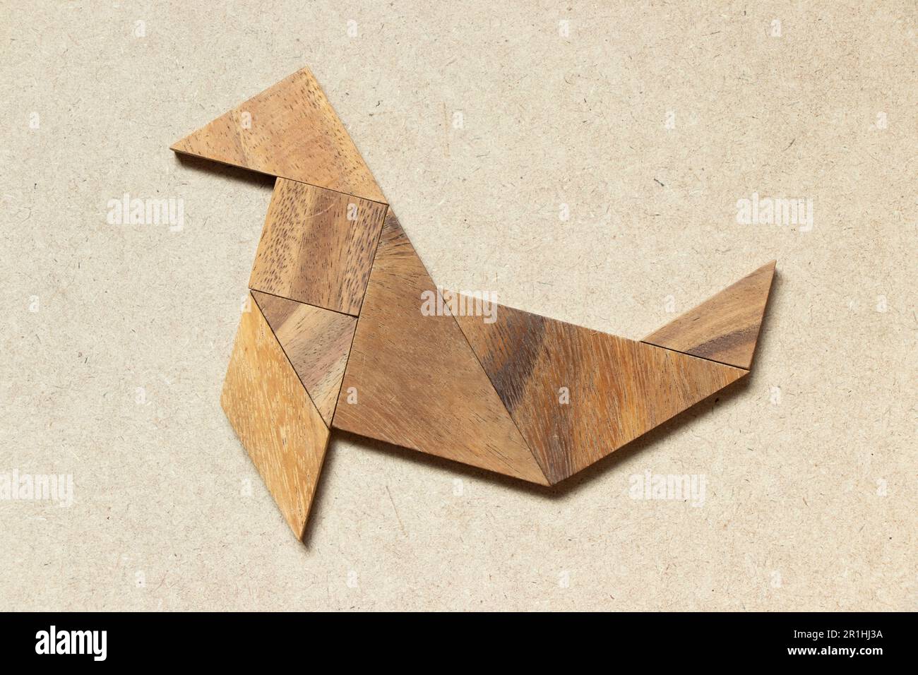 Wooden tangram in seal or sea lion shape on wood background Stock Photo ...