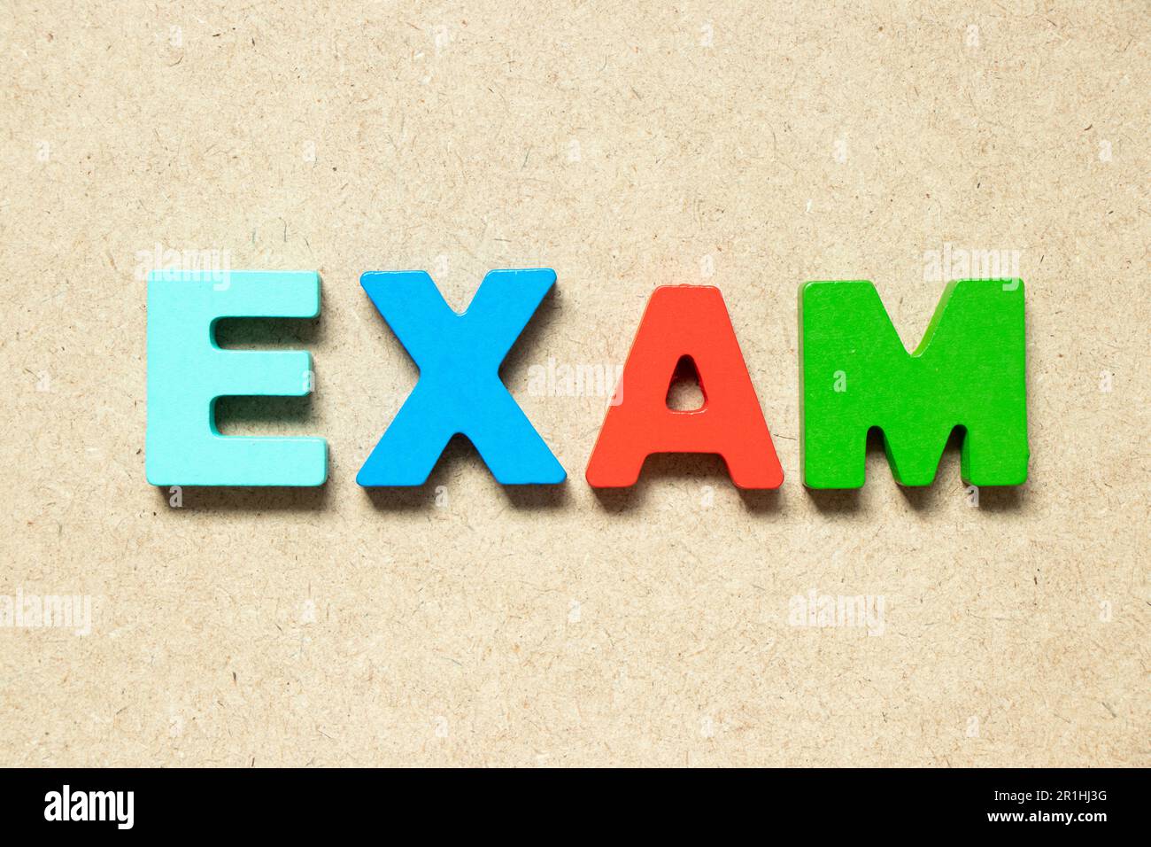 Color alphabet letter in word exam on wood background Stock Photo - Alamy