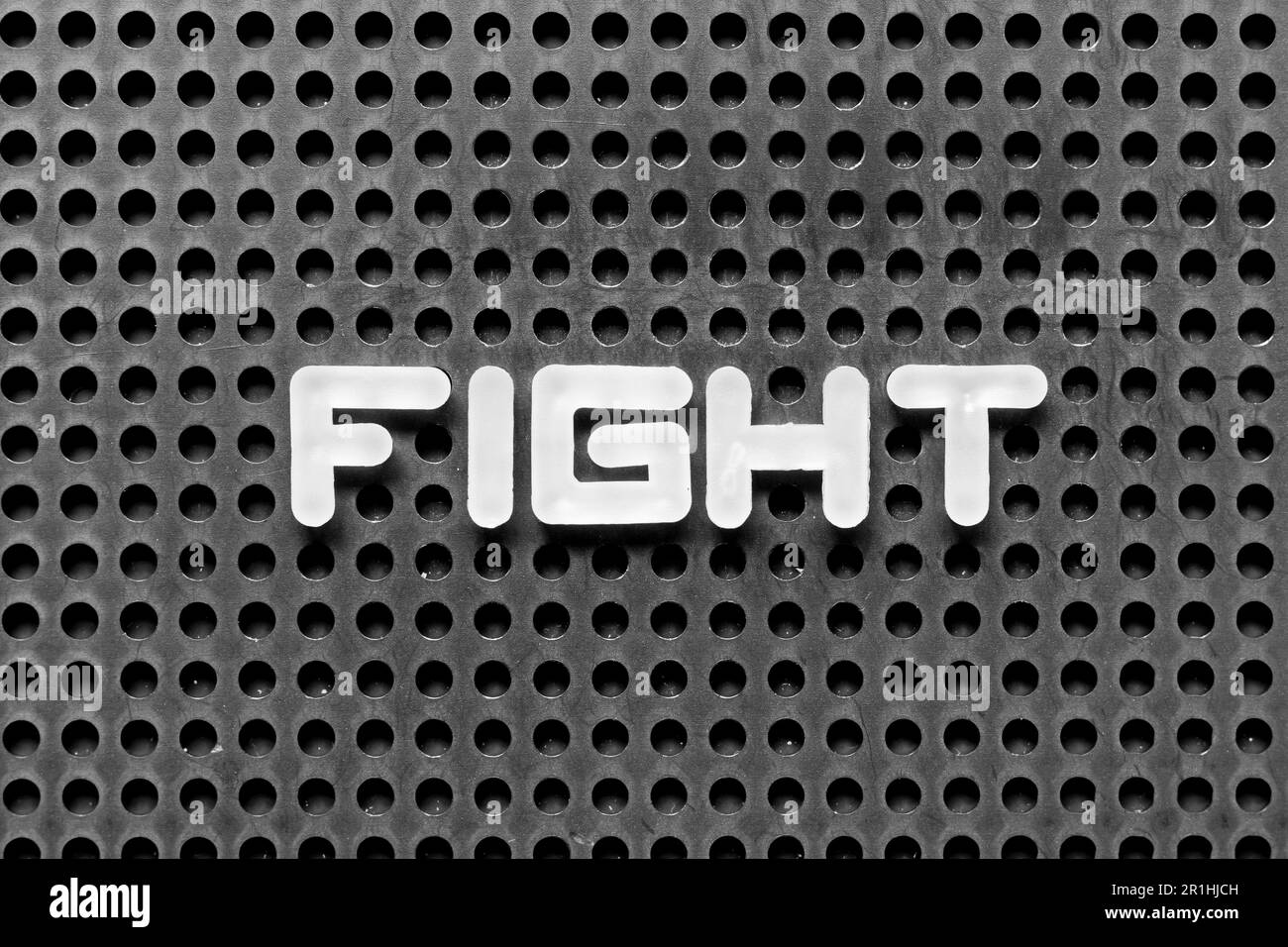 White alphabet letter in word fight on black pegboard background Stock ...