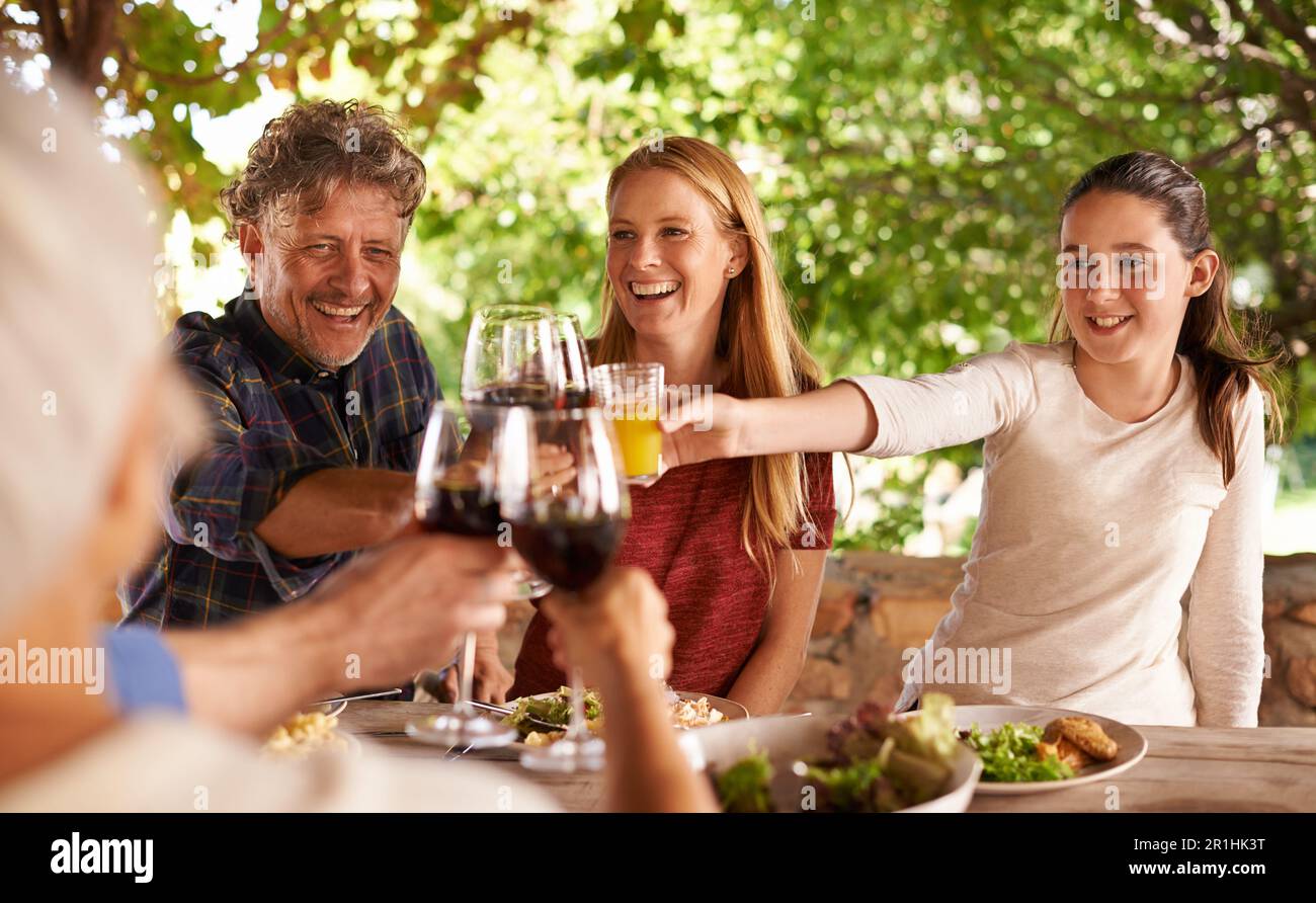 Family, group and wine glass for toast at table for celebration, food ...