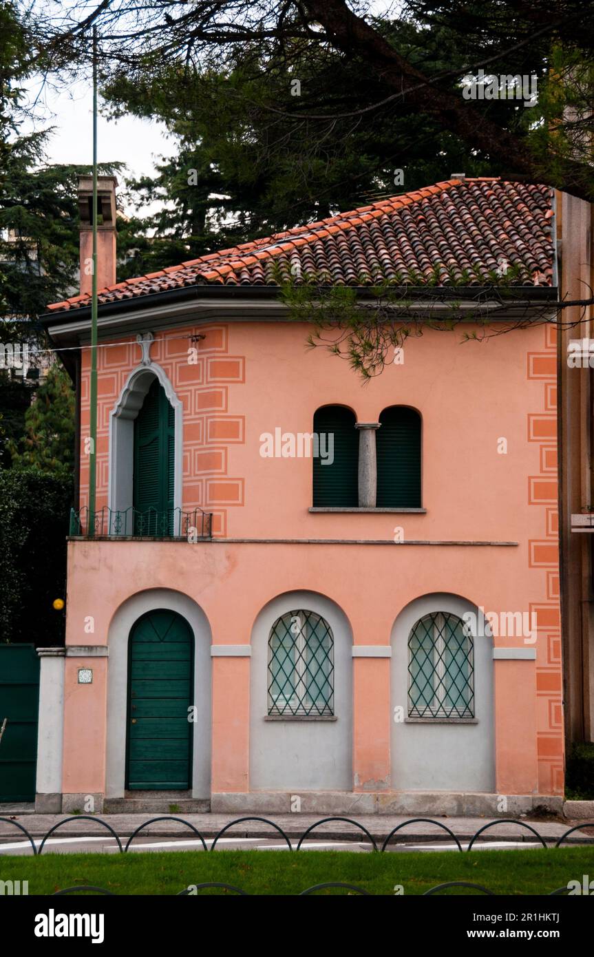 Salmon color house in Lecco on the shore of Lake Como in Northern Italy ...
