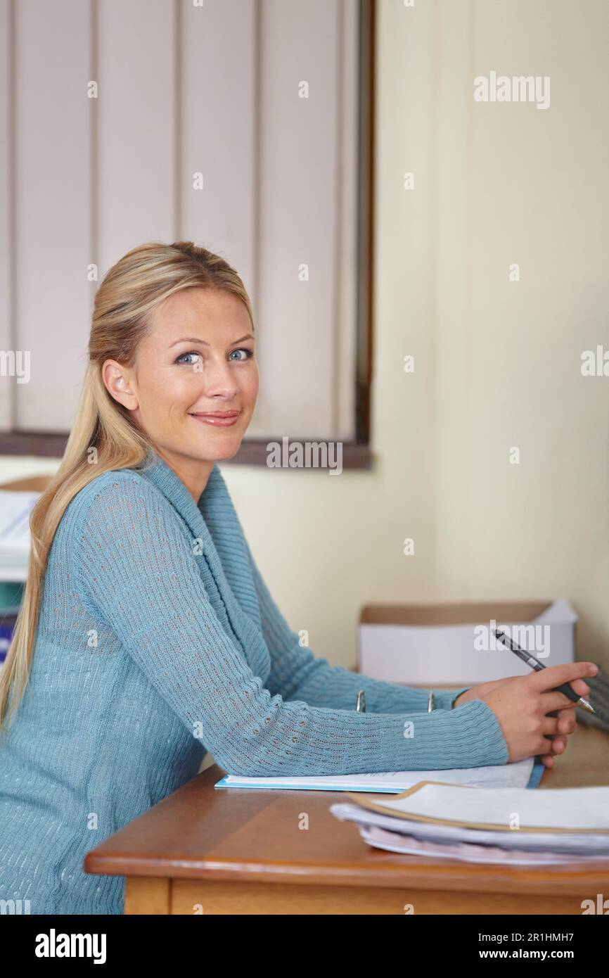 Woman, portrait and teacher grading in school with paperwork on desk in ...