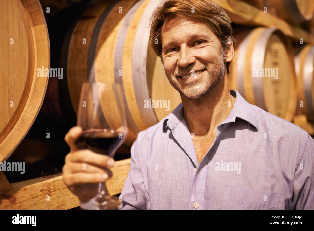 Portrait, wine and taste with a man in the cellar of a distillery on a ...