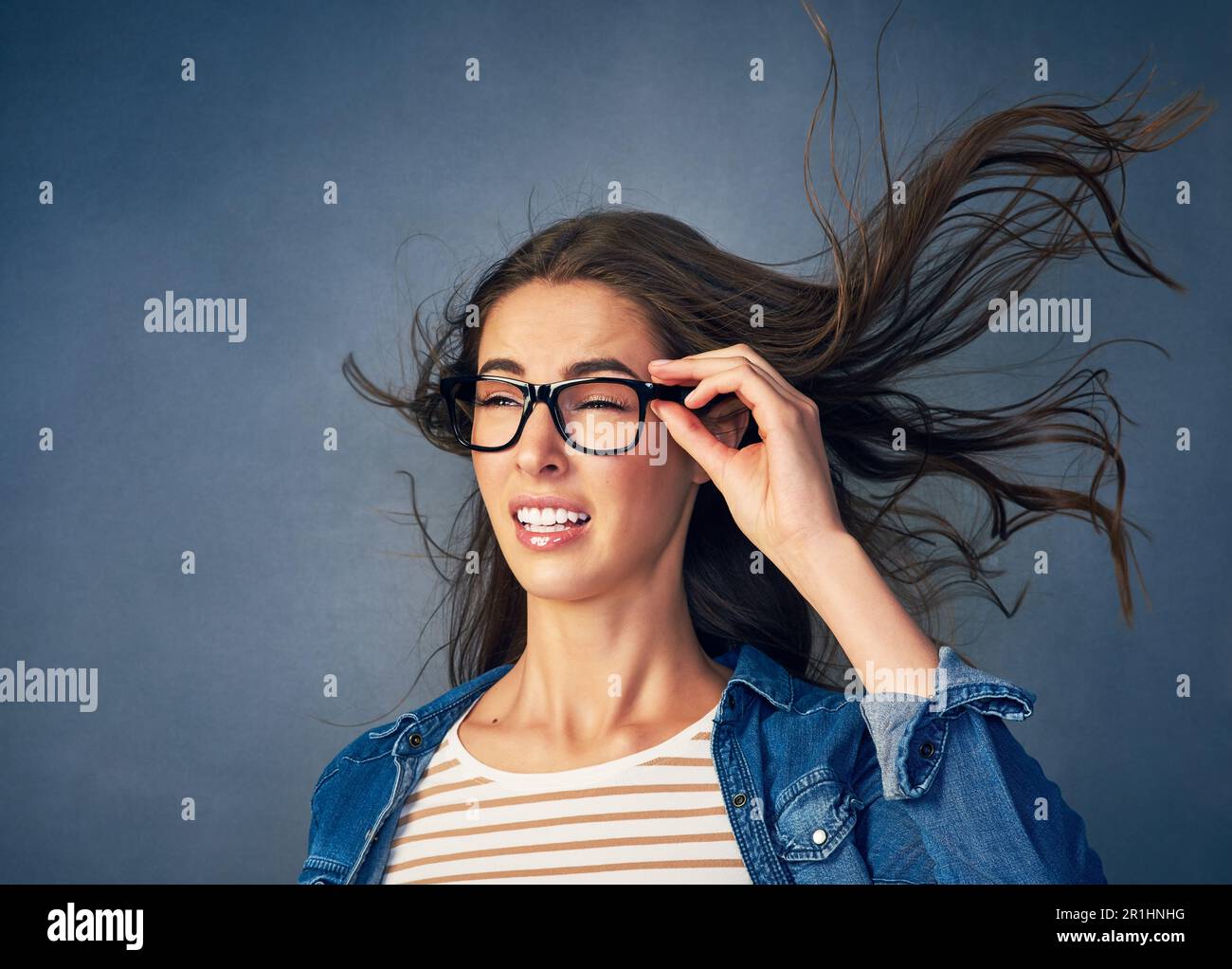 Its getting pretty windy in here. a happy young woman with air being ...