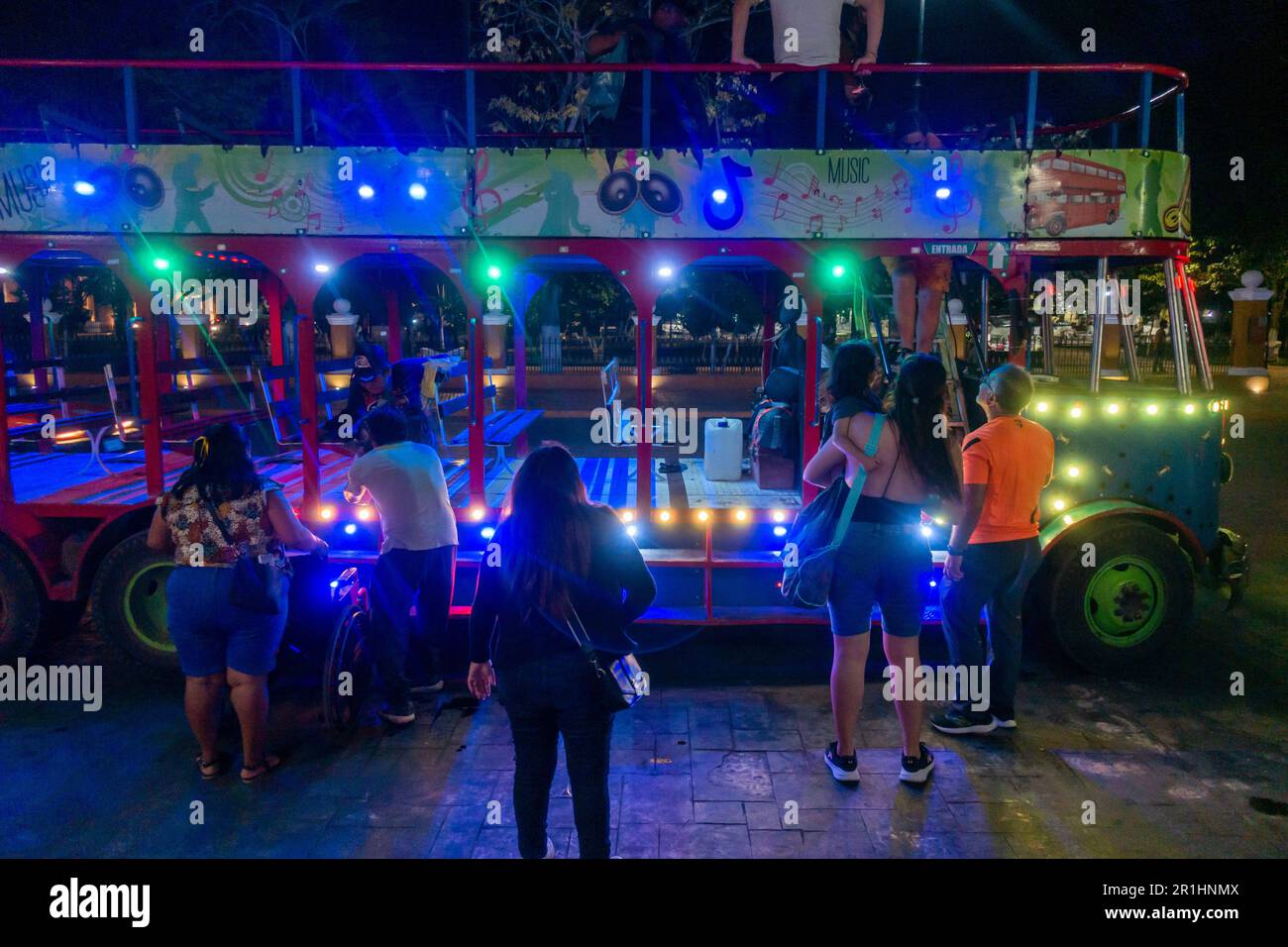 people getting off a local sightseeing bus in downtown Merida Yucatan ...