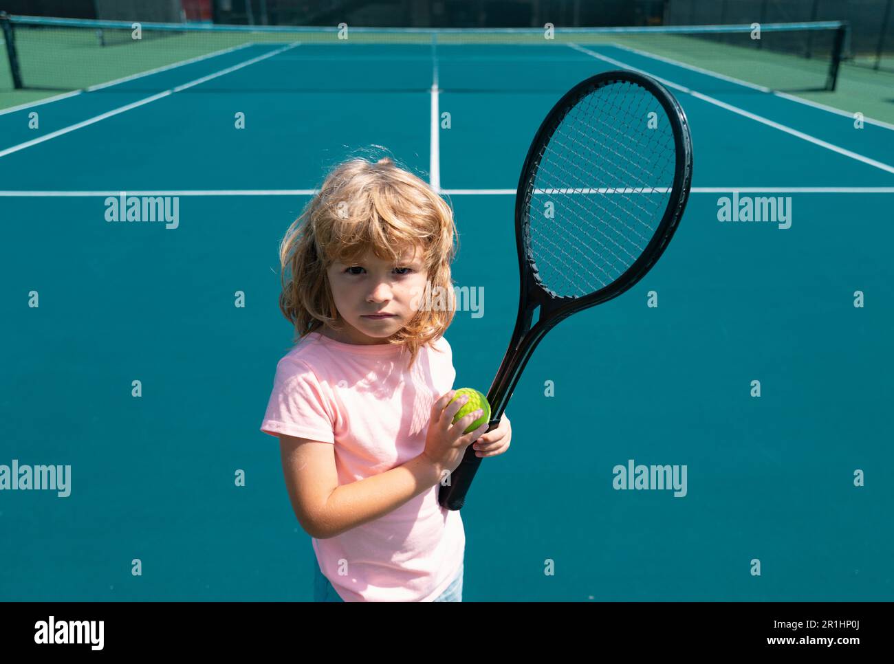 Child with tennis racket and ball on tennis court outdoor. Sport ...