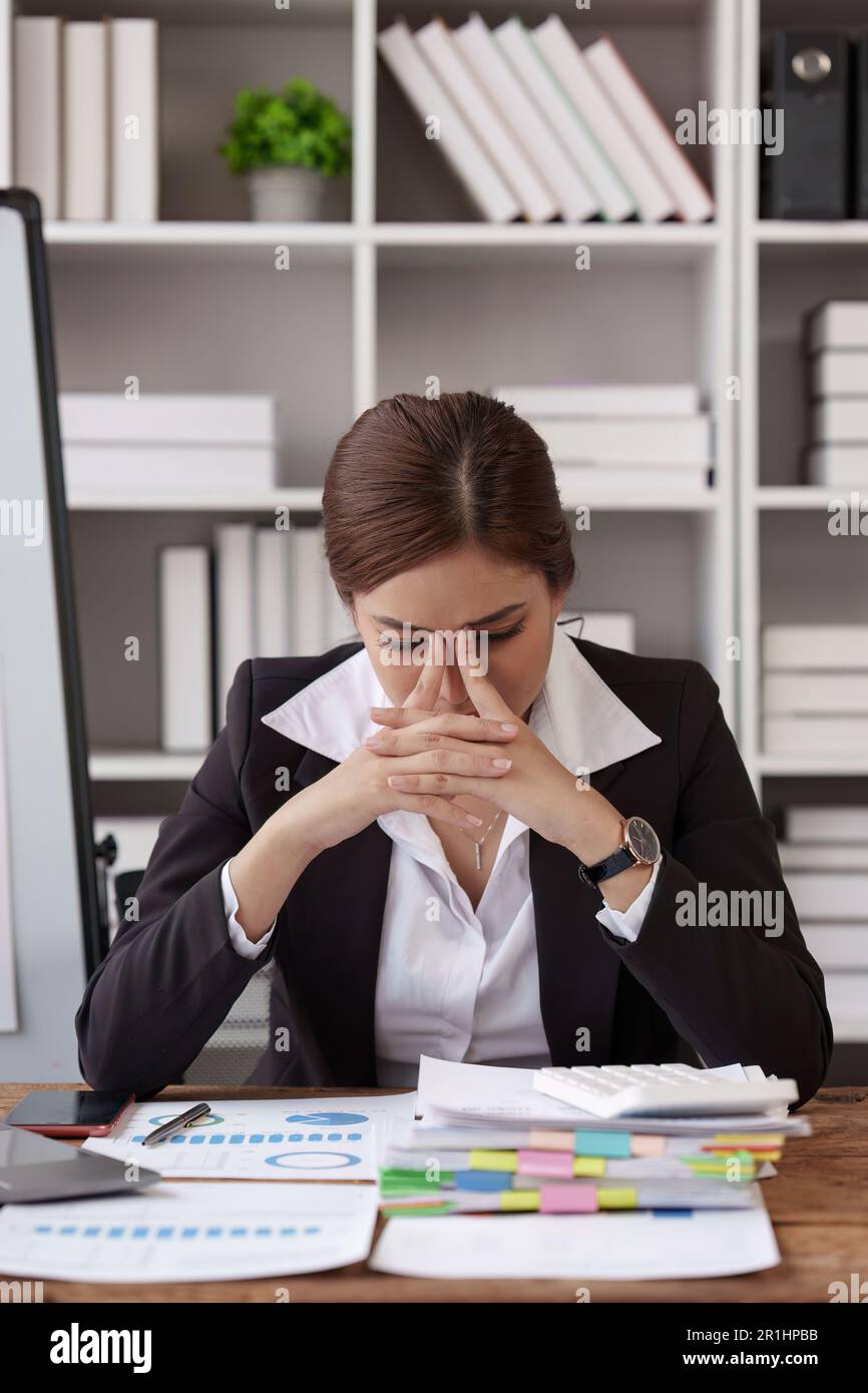 Employee feeling tired stressed with her work in the office, sad ...