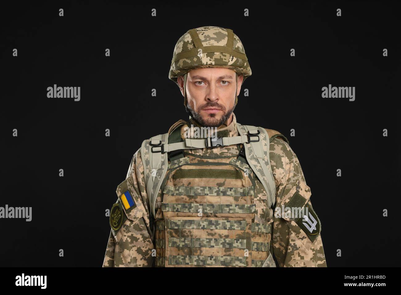 Soldier in Ukrainian military uniform on black background Stock Photo ...